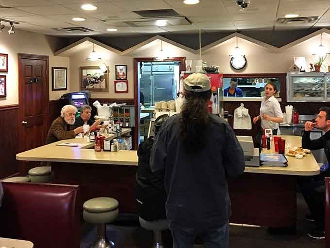 The counter where magic happens and orders fly, staffed by folks who've perfected the art of Cincinnati chili service.