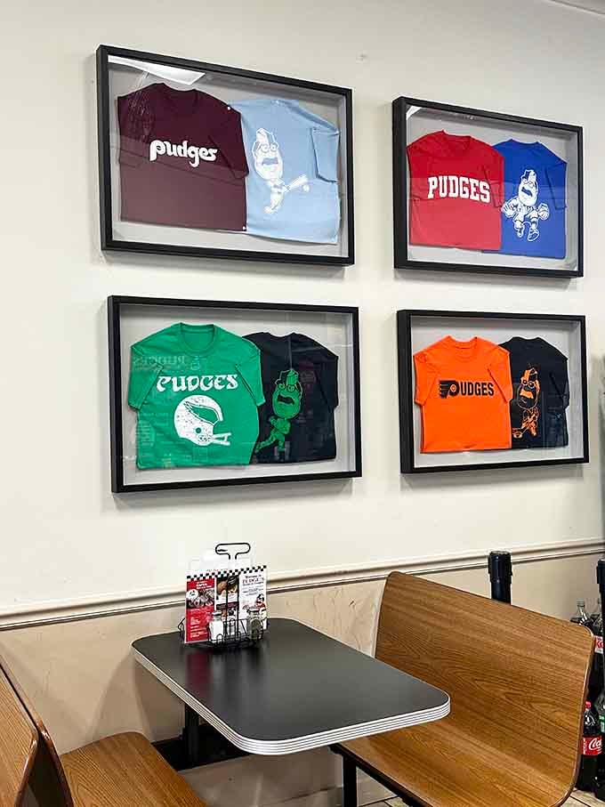 Framed t-shirts on the wall celebrating Pudge's legacy, like a hall of fame for carb-loaded excellence.