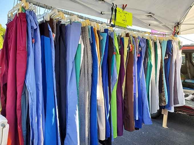 Rows of pants hanging like a fabric rainbow, waiting to find their next adventure on someone's back.