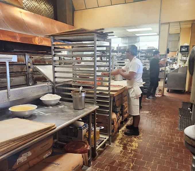 Behind the scenes, the kitchen crew works their magic, transforming simple ingredients into Springfield's legendary rectangular pizzas.
