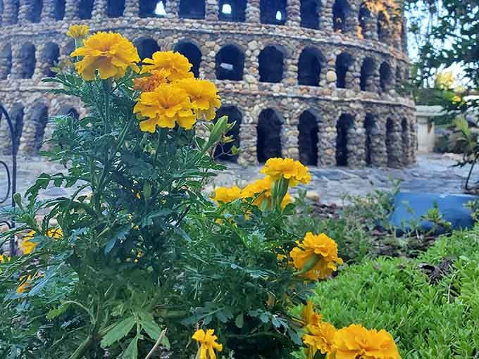 Yellow blooms add cheerful pops of color against the stone structures, nature's way of applauding human creativity.
