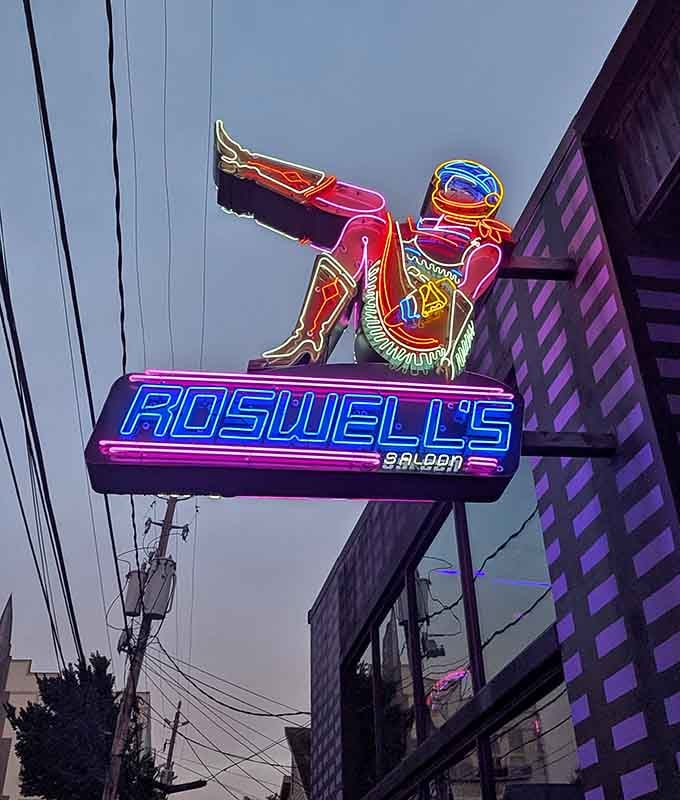 The neon cowboy astronaut sign outside waves hello, promising adventures that are truly out of this world inside.