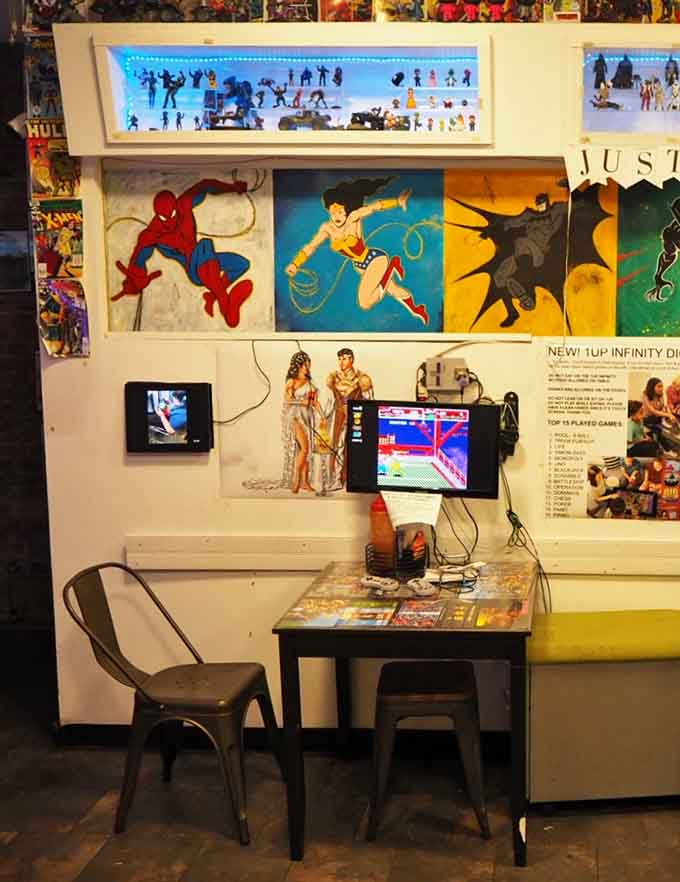 Spider-Man and Wonder Woman watching over your meal, because even superheroes appreciate a really good burger.