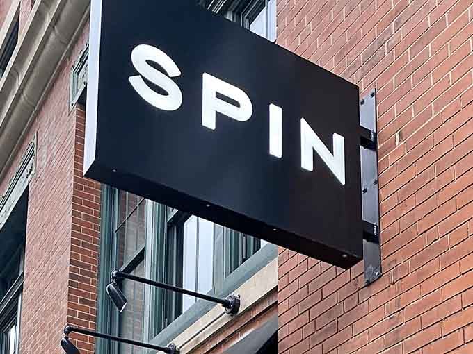 The SPIN signage beckons like a beacon for anyone seeking pizza, paddles, and possibly poor sportsmanship.