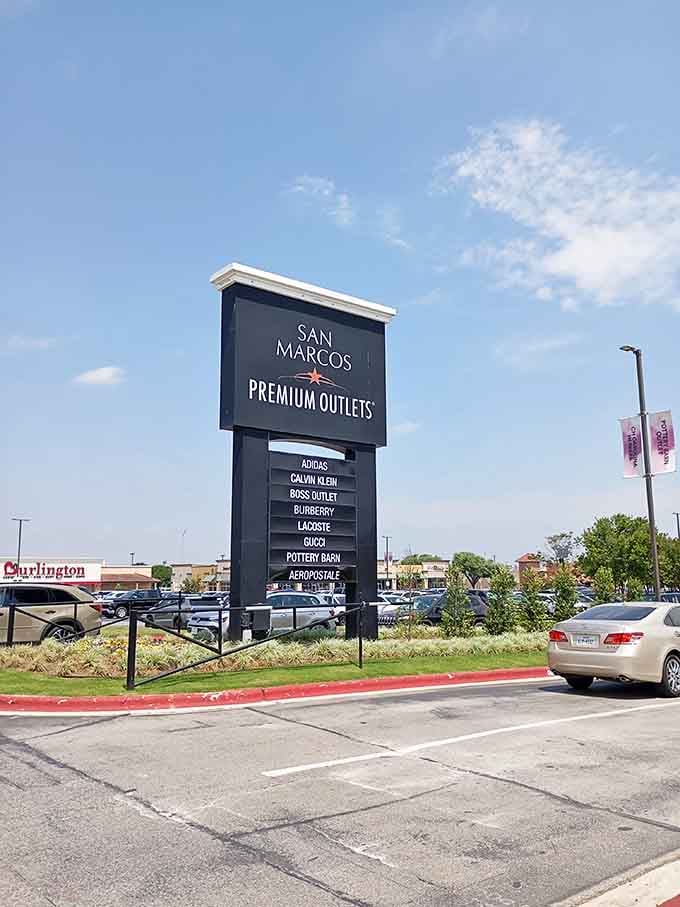 The main signage lists designer names like a greatest hits album, promising retail therapy for everyone.