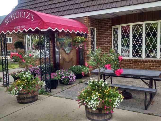 Outdoor seating surrounded by flowers offers a surprisingly pleasant spot to enjoy your feast when weather cooperates beautifully.
