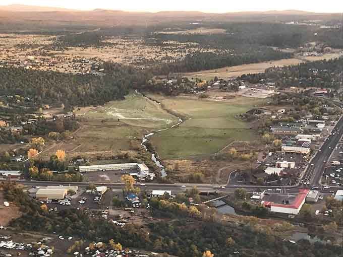 Aerial views reveal Show Low nestled in green valleys, a mountain oasis where your retirement dreams meet affordable reality.