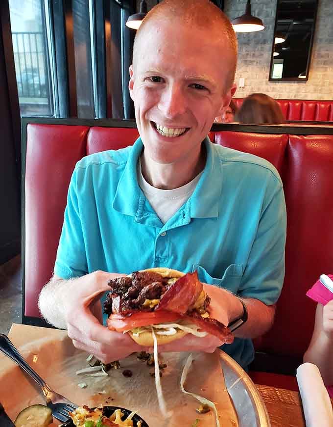 Pure joy captured in one smile, proving great barbecue creates happiness that's impossible to hide or fake.