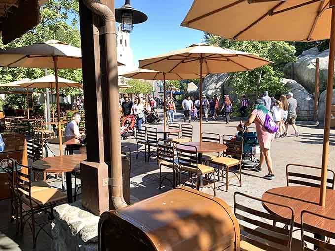 Outdoor seating with umbrellas provides the perfect spot for people-watching while you digest your aviation-themed feast.