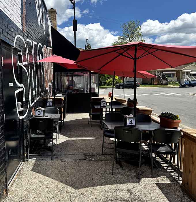 Shaded patio seating under cheerful umbrellas transforms sidewalk dining into your own personal barbecue oasis on Pulaski.