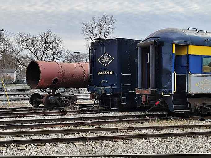 The railway yard sprawls with vintage equipment in various stages of restoration, each piece telling its own American railroad story.