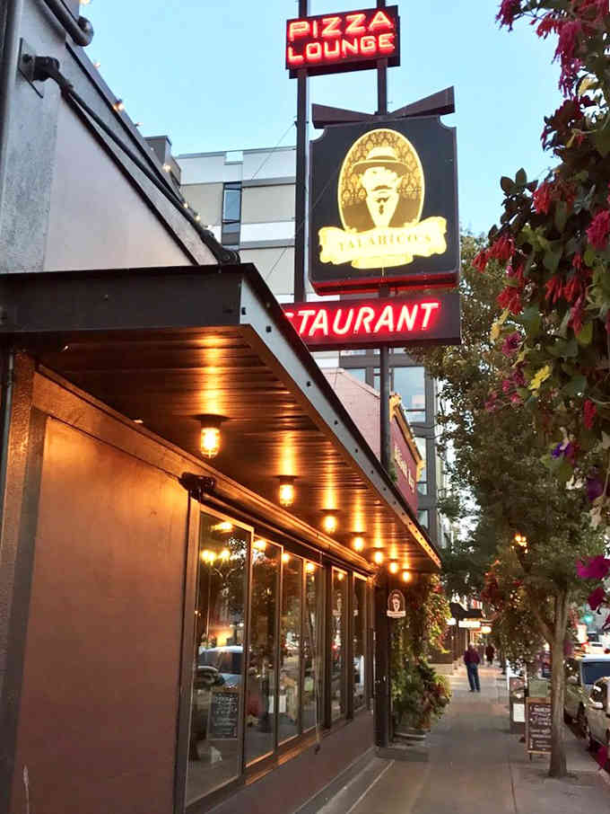 The glowing "Pizza Lounge" sign beckons like a beacon of hope for the hungry and the brave alike.