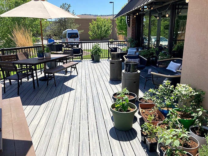 The outdoor patio beckons with potted plants and comfortable seating, perfect for sipping wine under Washington's beautiful blue skies.