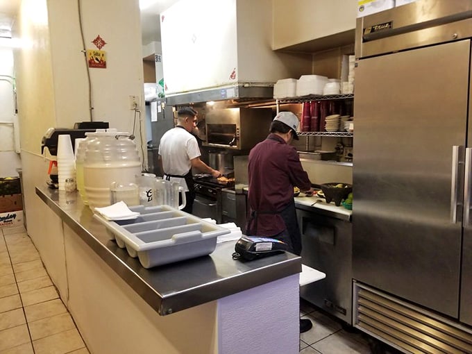 The kitchen crew hard at work, turning simple ingredients into the breakfast burritos that launched a thousand return visits.