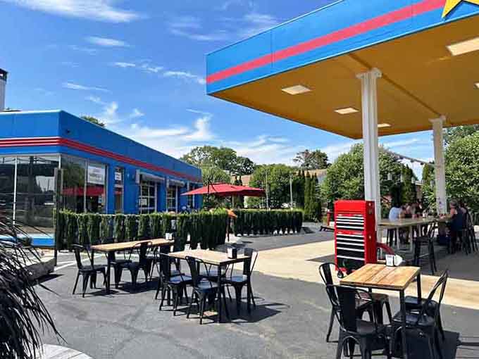 Outdoor seating under the old gas canopy transforms what once fueled cars into what now fuels happiness.