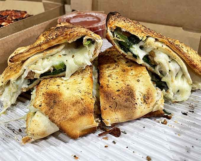 Stromboli sliced and ready, looking like the pizza's cooler cousin who studied abroad and came back sophisticated.