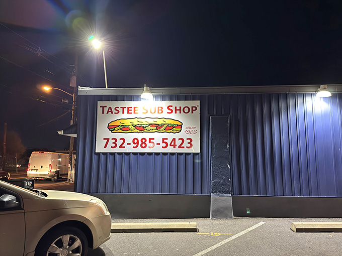 The parking lot at night, quiet now but soon to fill with folks craving authentic Jersey subs.