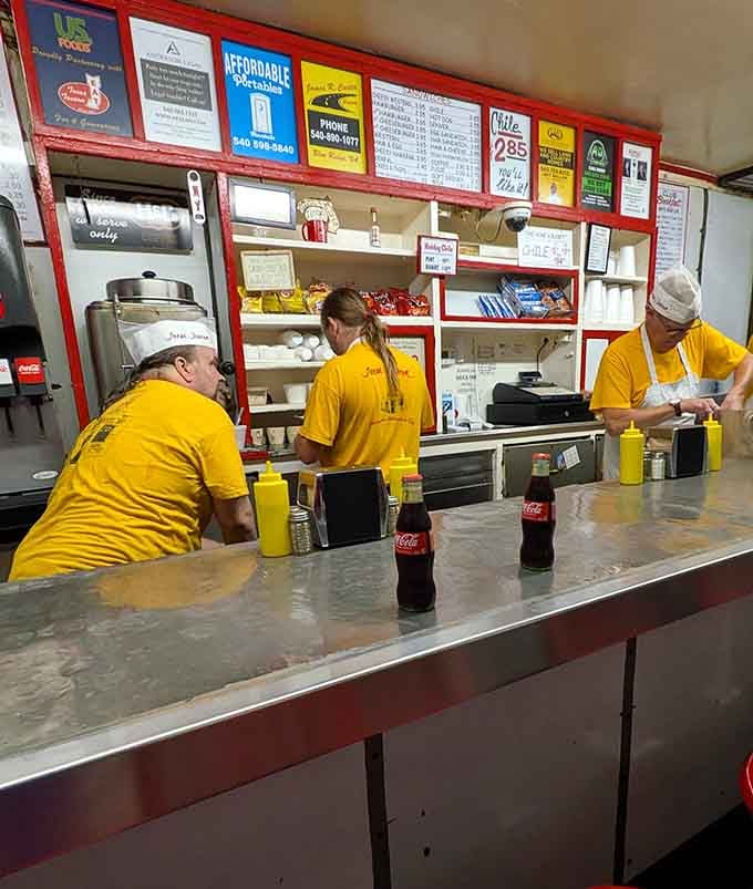 The crew in yellow, working in perfect sync like a well-oiled machine that happens to make incredible food.