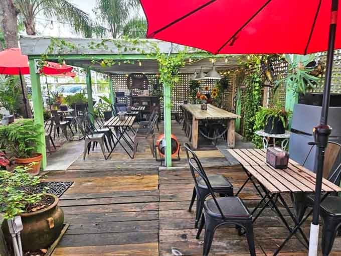 Red umbrellas dot the wooden deck like cheerful sentries guarding your perfect morning escape from reality.