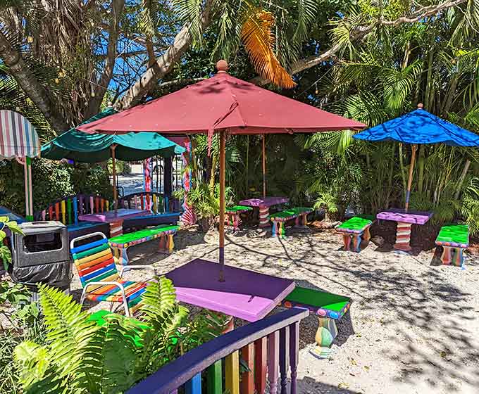 The outdoor seating area continues the color explosion theme, proving The Bubble Room never takes a decorating break.