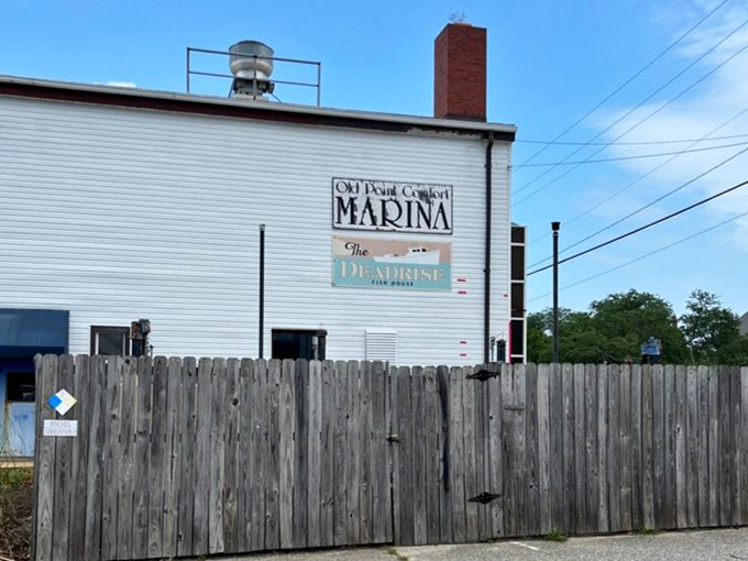 Old Point Comfort Marina signage marks the spot where The Deadrise serves up Chesapeake Bay magic to hungry diners daily.