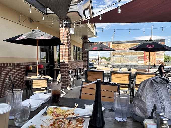 Patio seating with string lights overhead makes every meal feel like a special occasion under big skies.