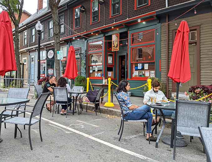 Outdoor seating on a nice day in Inman Square, where you can enjoy your meal and watch Cambridge life unfold.