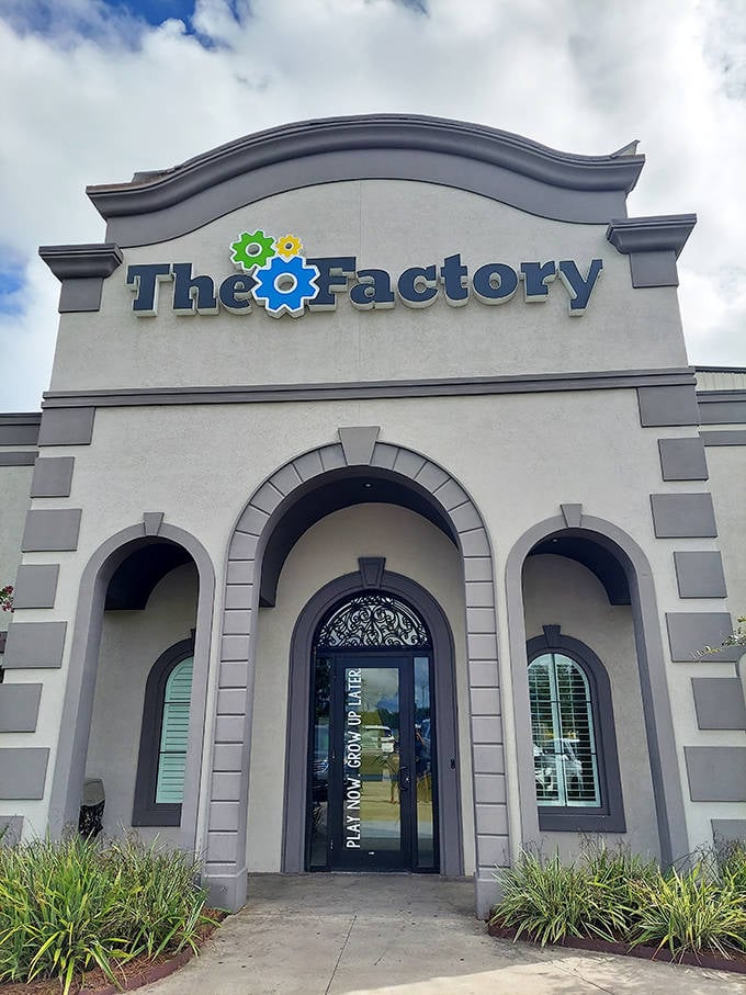 The Factory's entrance beckons with architectural charm, those gear logos promising mechanical fun waiting just beyond the doors.