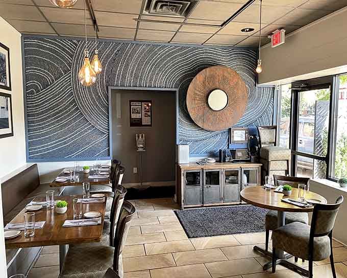 Artistic wall details and thoughtful lighting transform this dining space into something special without trying too hard.