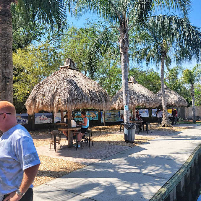 Palm-thatched huts provide shade for outdoor dining, turning lunch into a tropical escape without leaving Homosassa.