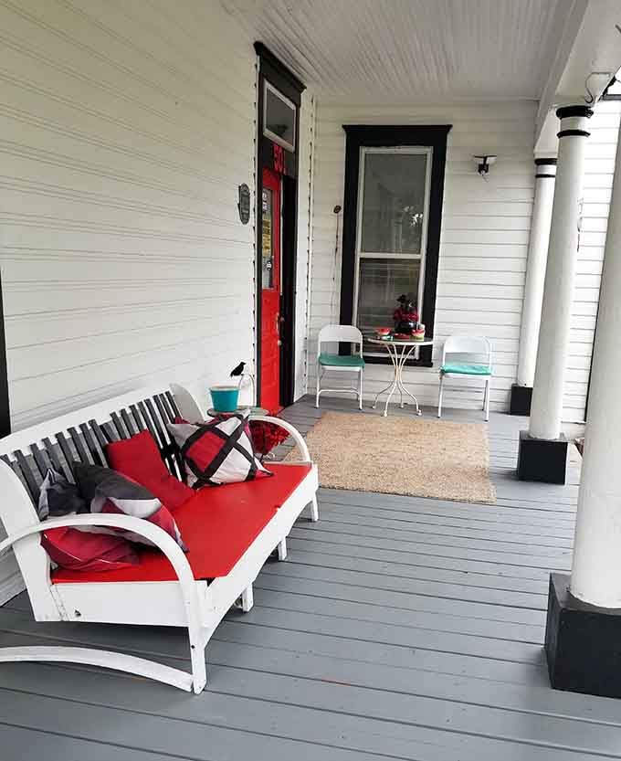 That welcoming front porch proves even haunted houses appreciate good Southern hospitality and comfortable seating arrangements.