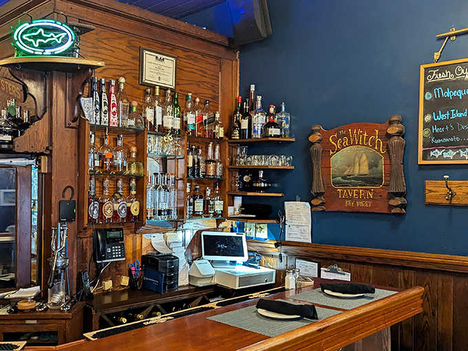 The bar area gleams with bottles and possibilities, ready to pair the perfect drink with your seafood selection.