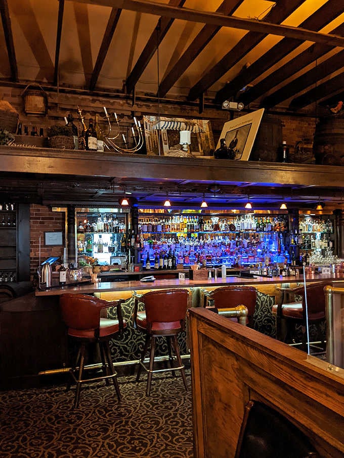 The bar glows with blue-lit bottles like a shrine to spirits, inviting you to start your evening properly.
