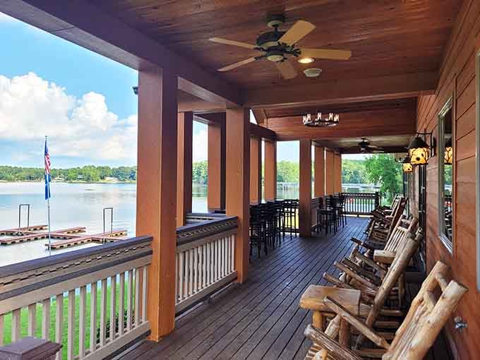 A porch with rocking chairs overlooking the lake, where post-dinner relaxation becomes a mandatory life requirement.