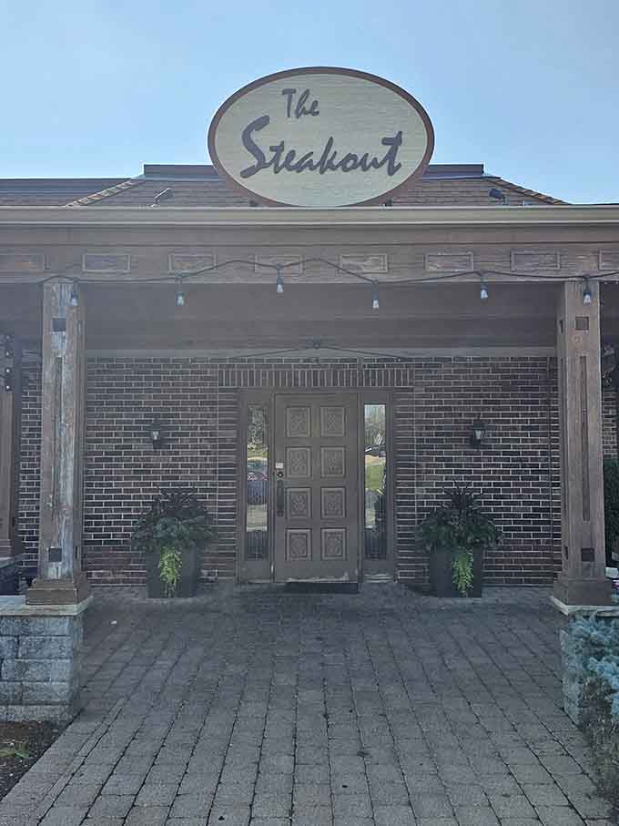 The classic oval sign and brick facade prove you can't judge a steakhouse by its shopping center.