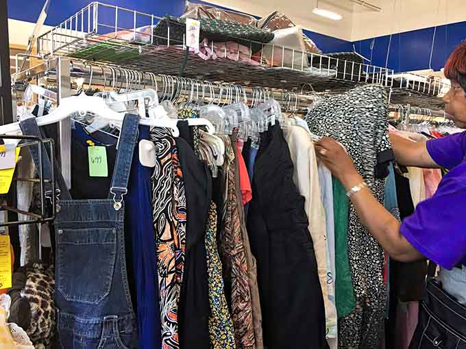 Someone's browsing the racks where yesterday's wardrobe becomes tomorrow's perfect find at unbeatable prices.