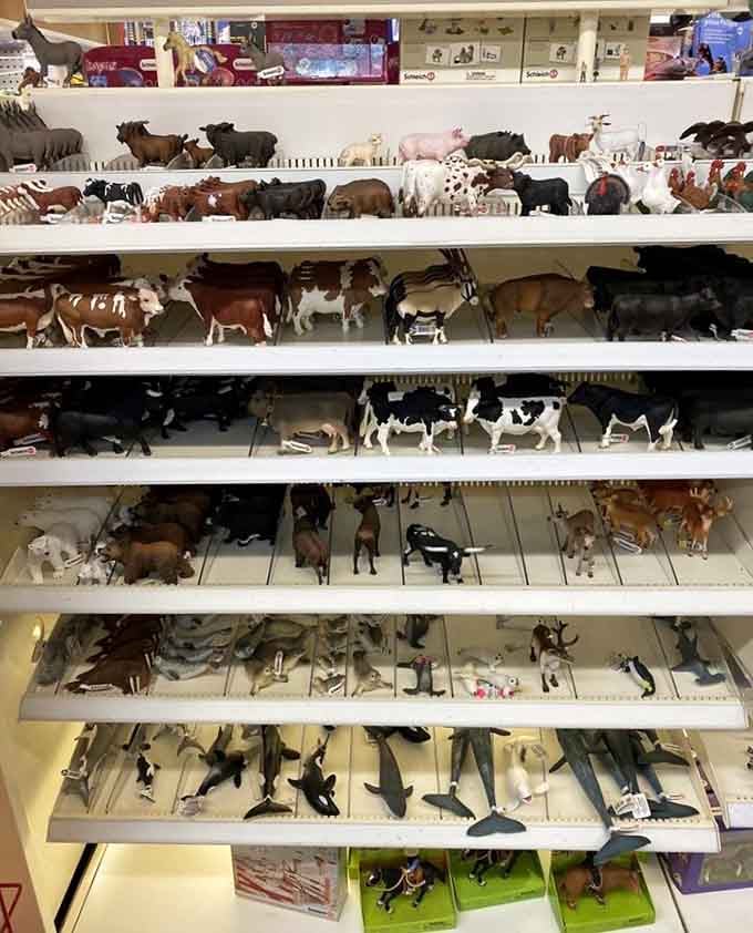 Farm animals lined up like Noah's Ark met a collector's convention, each one perfectly detailed and waiting.