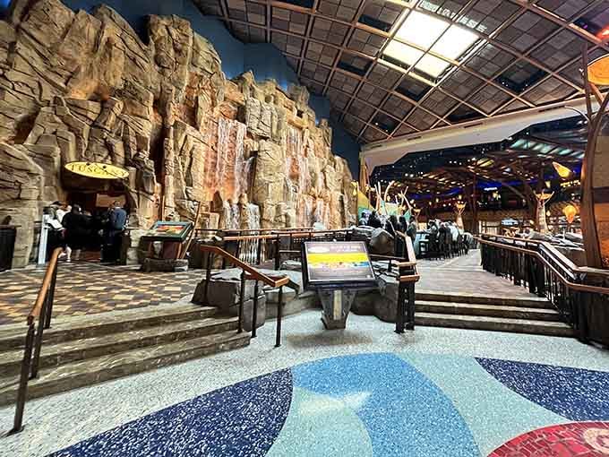 The entryway mosaic floor pattern guides you toward that waterfall like breadcrumbs, except way fancier.