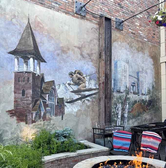 A beautiful mural depicting Leadville's mining heritage adorns the outdoor space, blending art with alfresco dining perfectly.