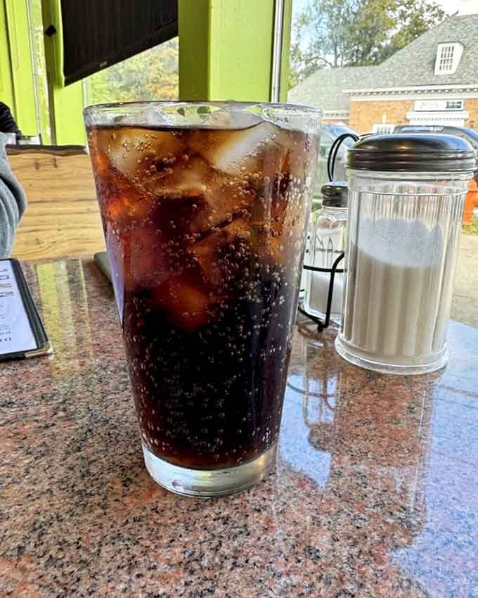 Ice-cold cola in a proper glass with condensation running down the sides, because some things shouldn't change with time.