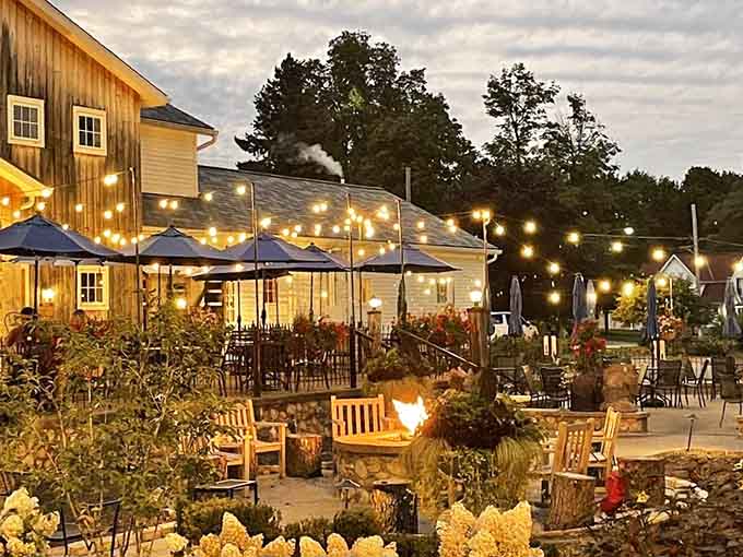 The outdoor patio with fire pit and string lights transforms dinner into a magical evening under the stars.