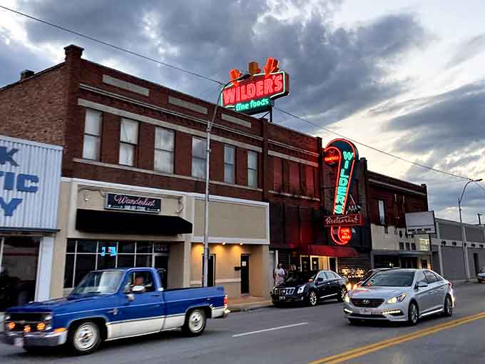 The Wilder's sign glowing against a dramatic sky is Joplin's way of saying dinner is about to get good.