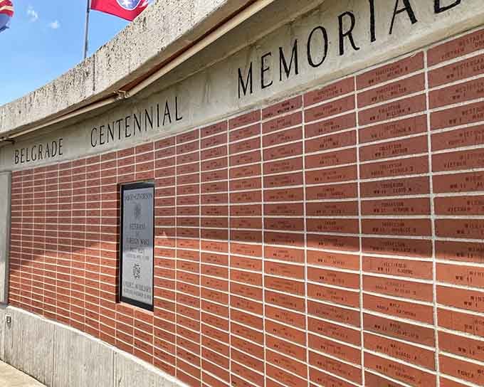 The memorial wall stretches impressively, each brick representing someone who helped make Belgrade what it is today.
