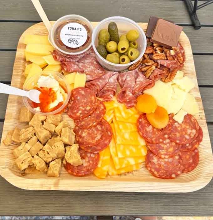 This charcuterie board loaded with meats, cheeses, and olives pairs perfectly with any wine you choose here.