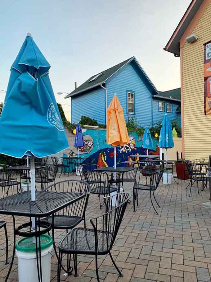 The outdoor patio offers al fresco dining with colorful umbrellas, perfect for people-watching while enjoying your feast.