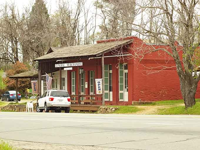 The old red general store sits peacefully among bare trees, a reminder of when this was a bustling stop.