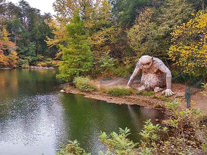 Nature's own gentle giant takes a contemplative pause by the water, surrounded by autumn's golden embrace.