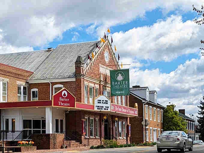 Historic brick buildings line this charming street where theater marquees promise entertainment that beats any streaming service.
