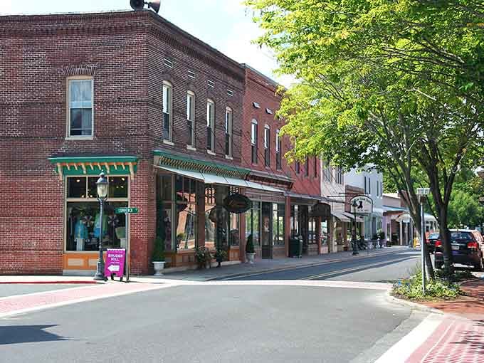 Brick storefronts and leafy trees create a Main Street so perfect it could be a movie set.