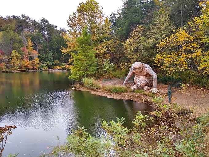 This gentle giant takes a sip from the pond, surrounded by autumn's golden palette like a scene from Narnia.